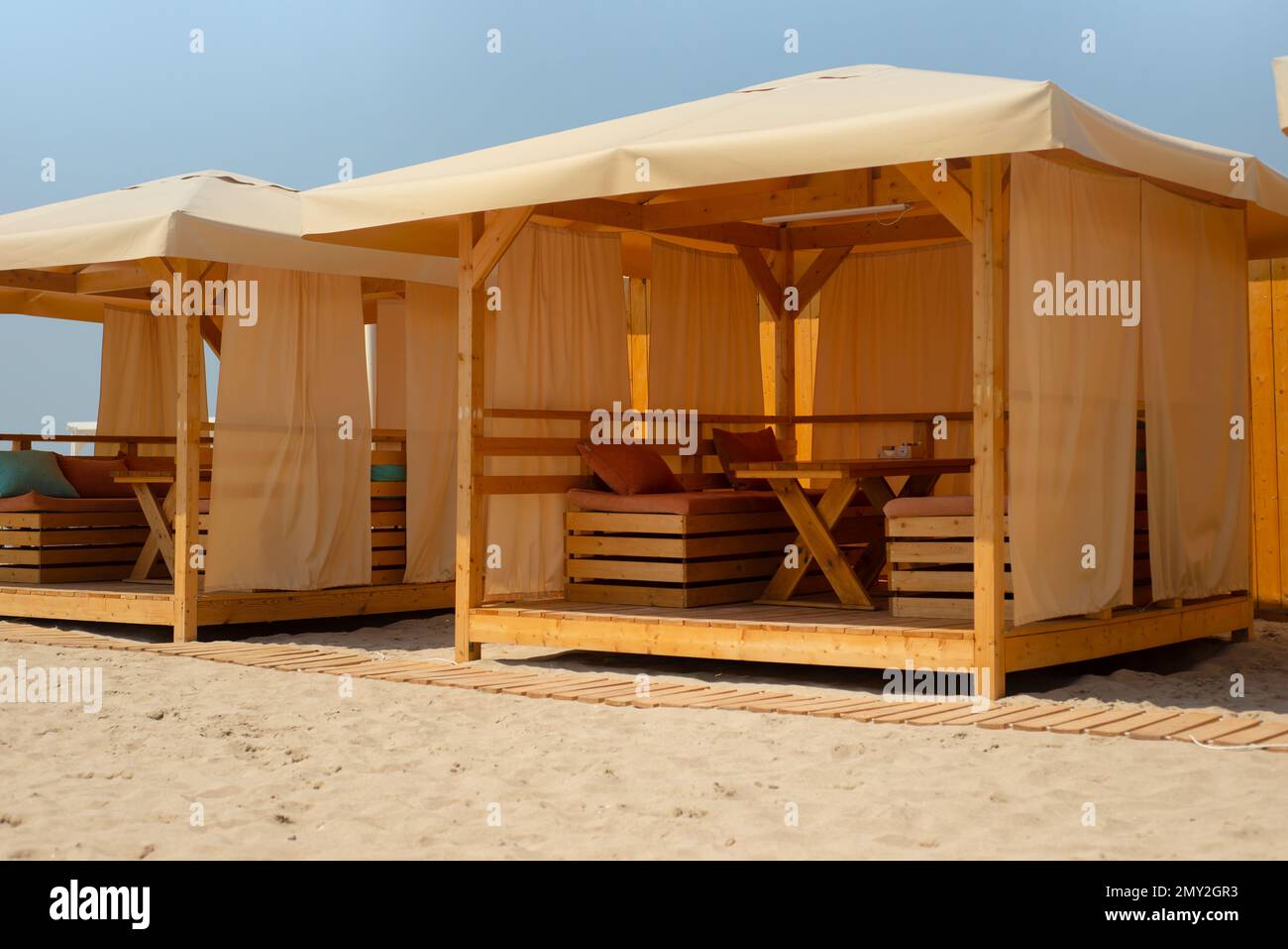 Wooden tents on the sandy beach. Cafe. Restaurant. Shady place for food ...