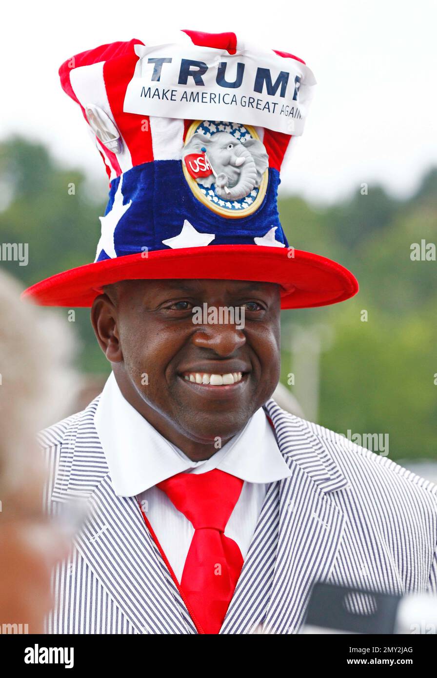 Philemon Williams sports his "Trump" stovepipe hat as he waits in line ...