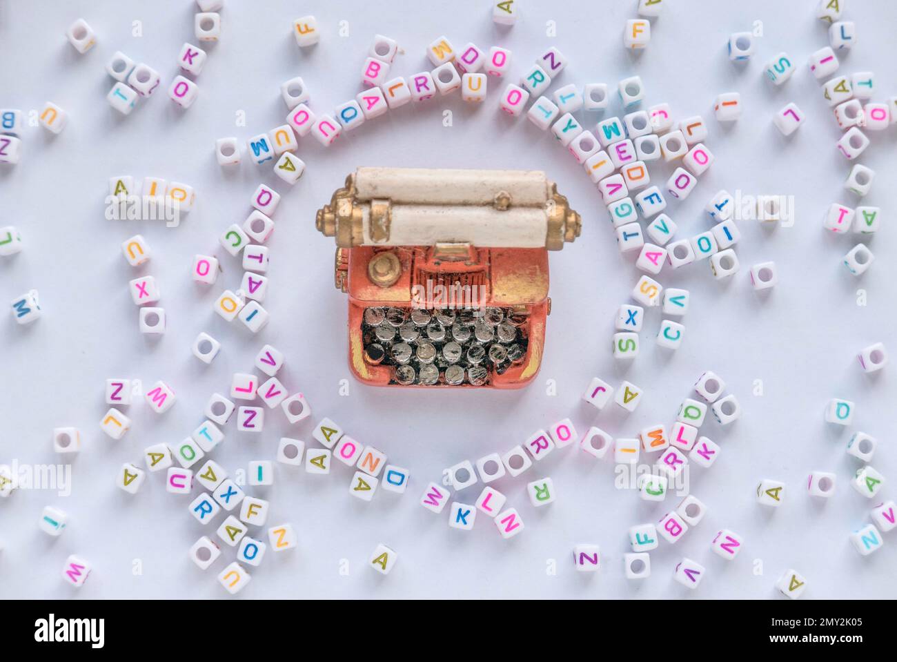 Alphabet beads with miniature typewriter on white background Stock ...