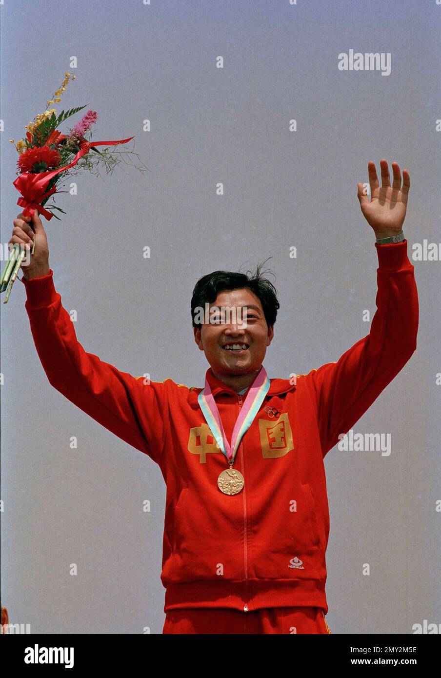 Wu Haifeng of China receives his gold medal in the men's free pistol competition in Los Angeles ...