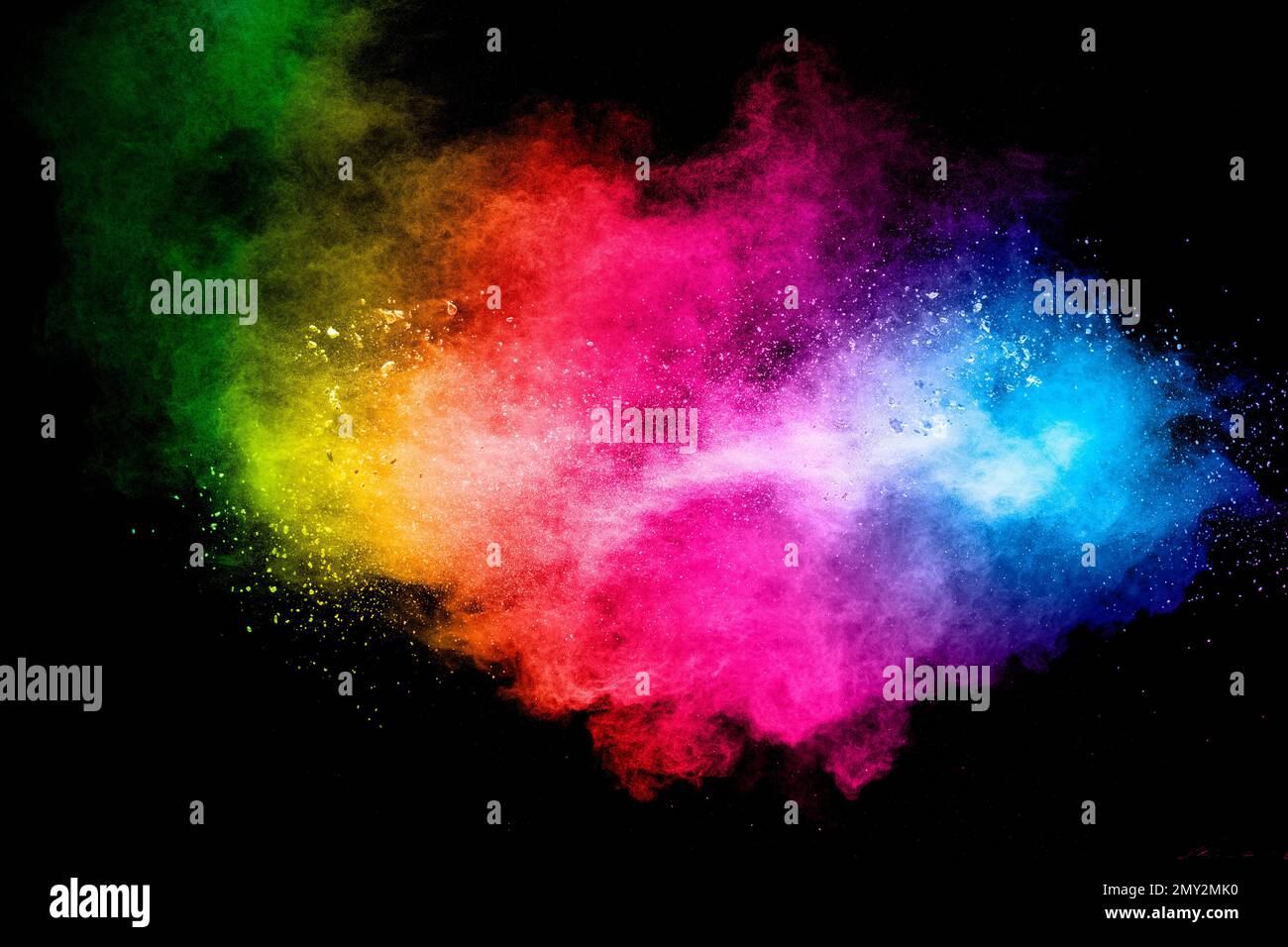 Launched multicolored powder on black background.Colorful dust ...