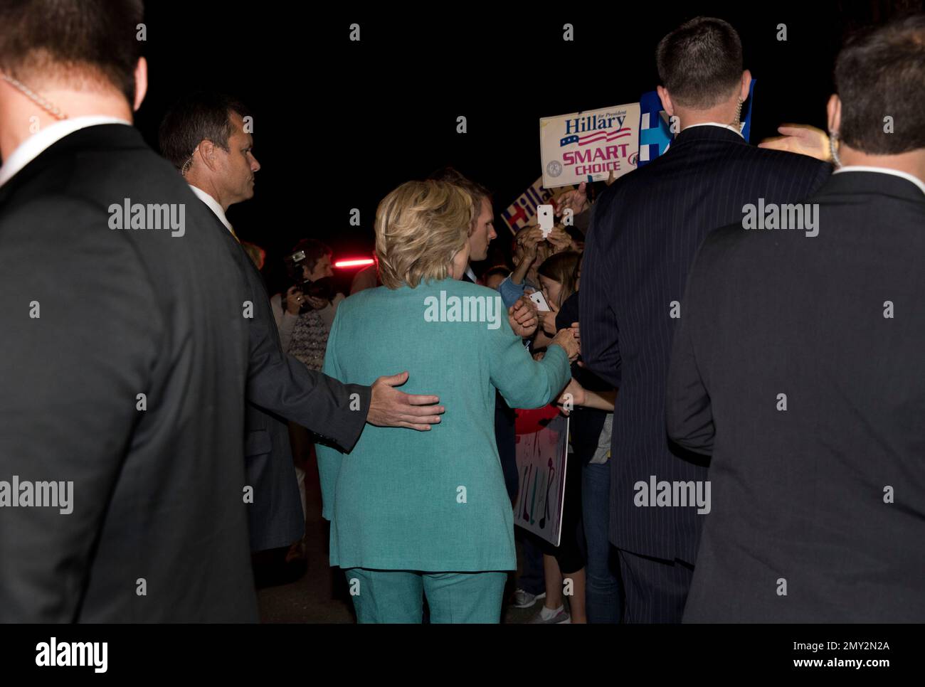 Democratic presidential nominee Hillary Clinton is surrounded by ...