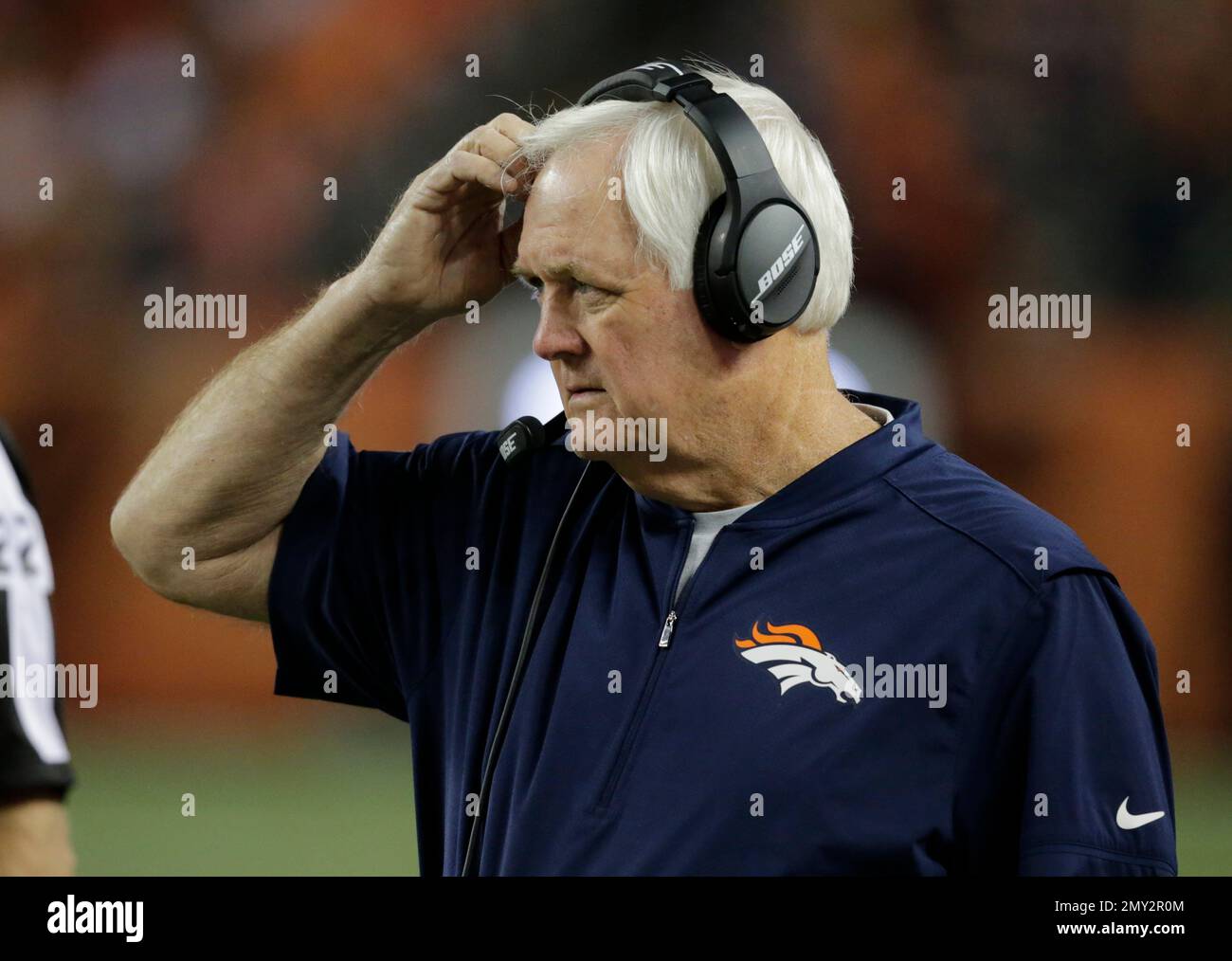 Denver Broncos defensive coordinator Wade Phillips wears a headset as ...