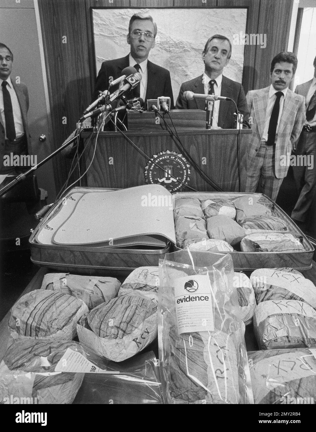 Special agents display 20 of 27 kilos of cocaine seized in the arrest ...