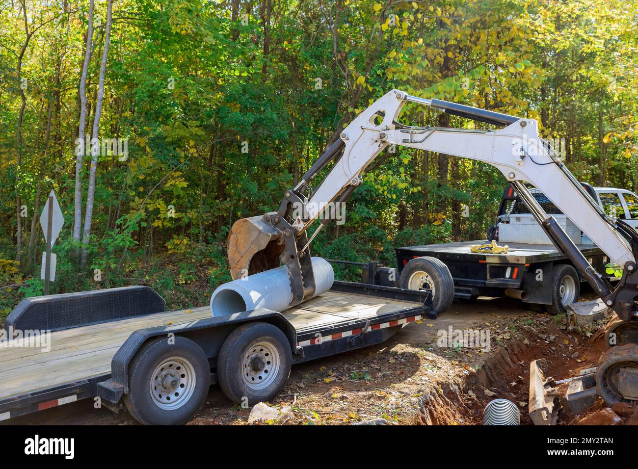 It is job of worker construction industry to lift concrete sewage pipes ...