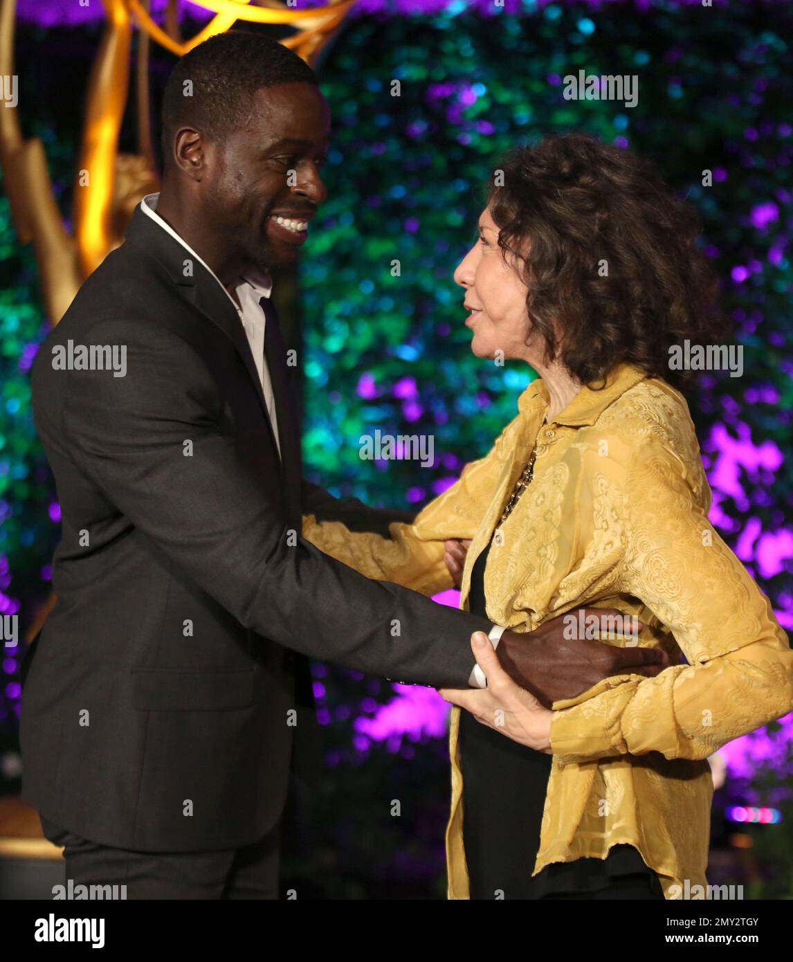 Sterling K. Brown, left, and Lily Tomlin hug at the Television Academy ...