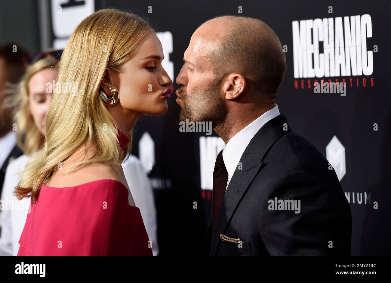 Jason Statham, right, a cast member in "Mechanic: Resurrection," kisses ...