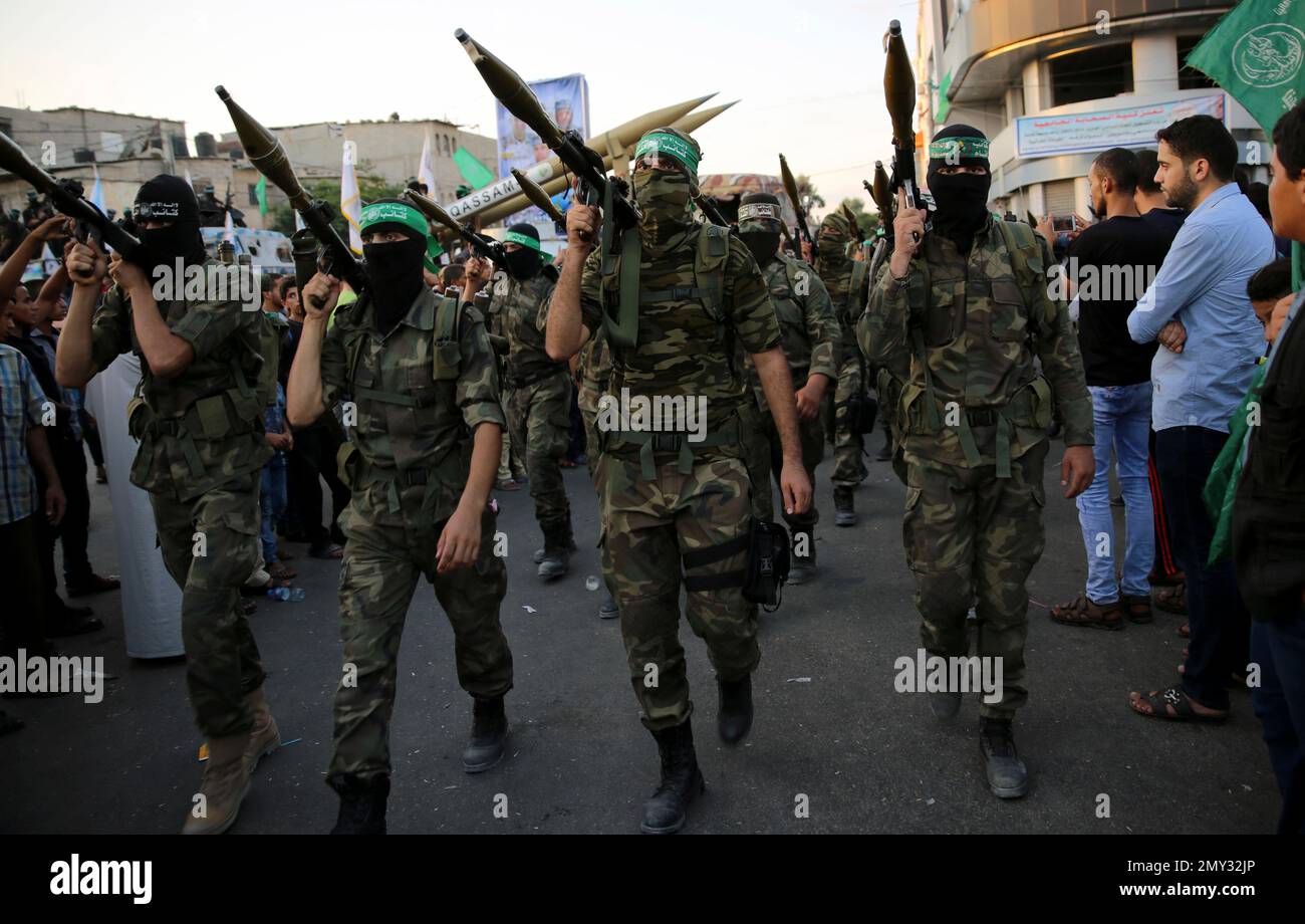 Palestinian masked members from the Izzedine al-Qassam Brigades, a ...