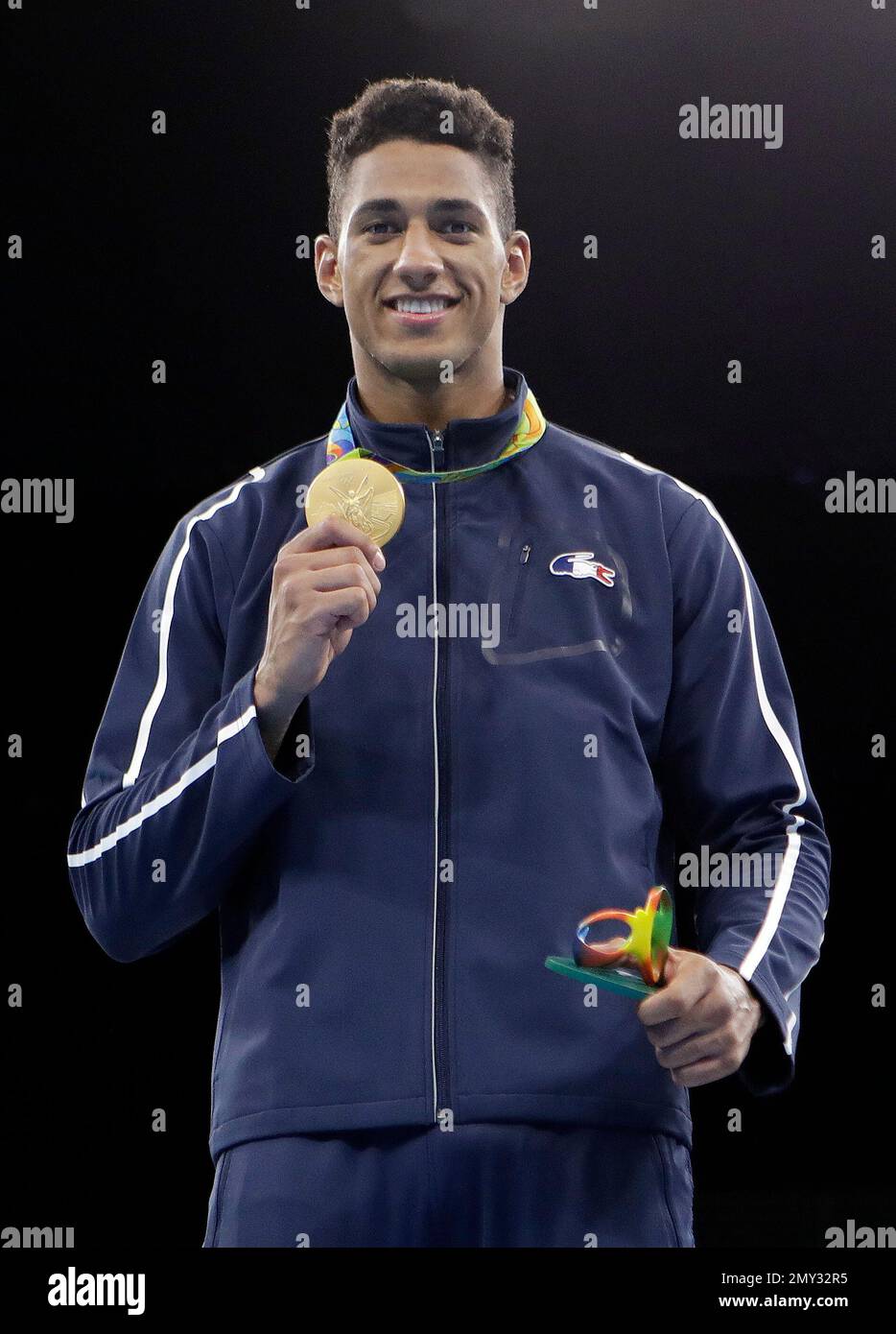 France's Tony Victor James Yoka displays his gold medal for the men's ...
