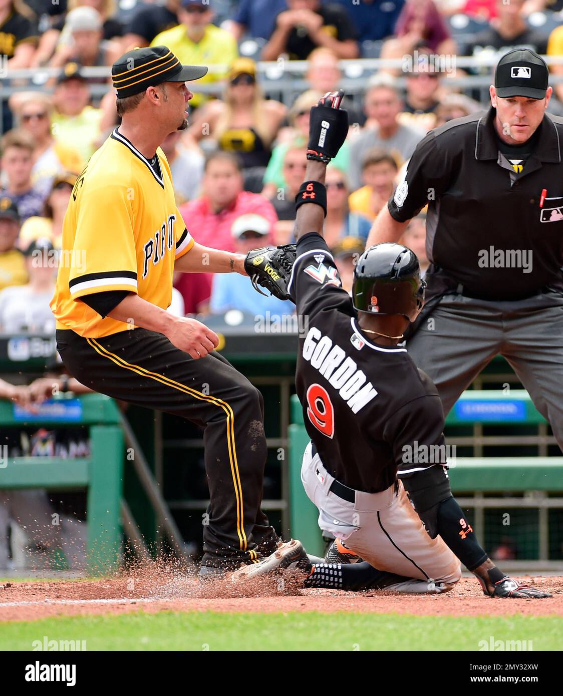 Miami Marlins' Dee Gordon scores on a wild pitch in front of Pittsburgh ...