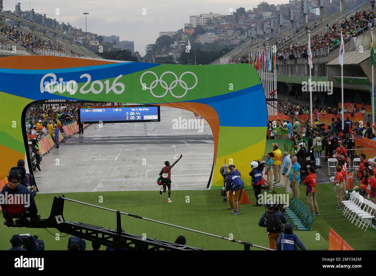 Kenya's Eliud Kipchoge celebrates after he crosses the finish line to ...