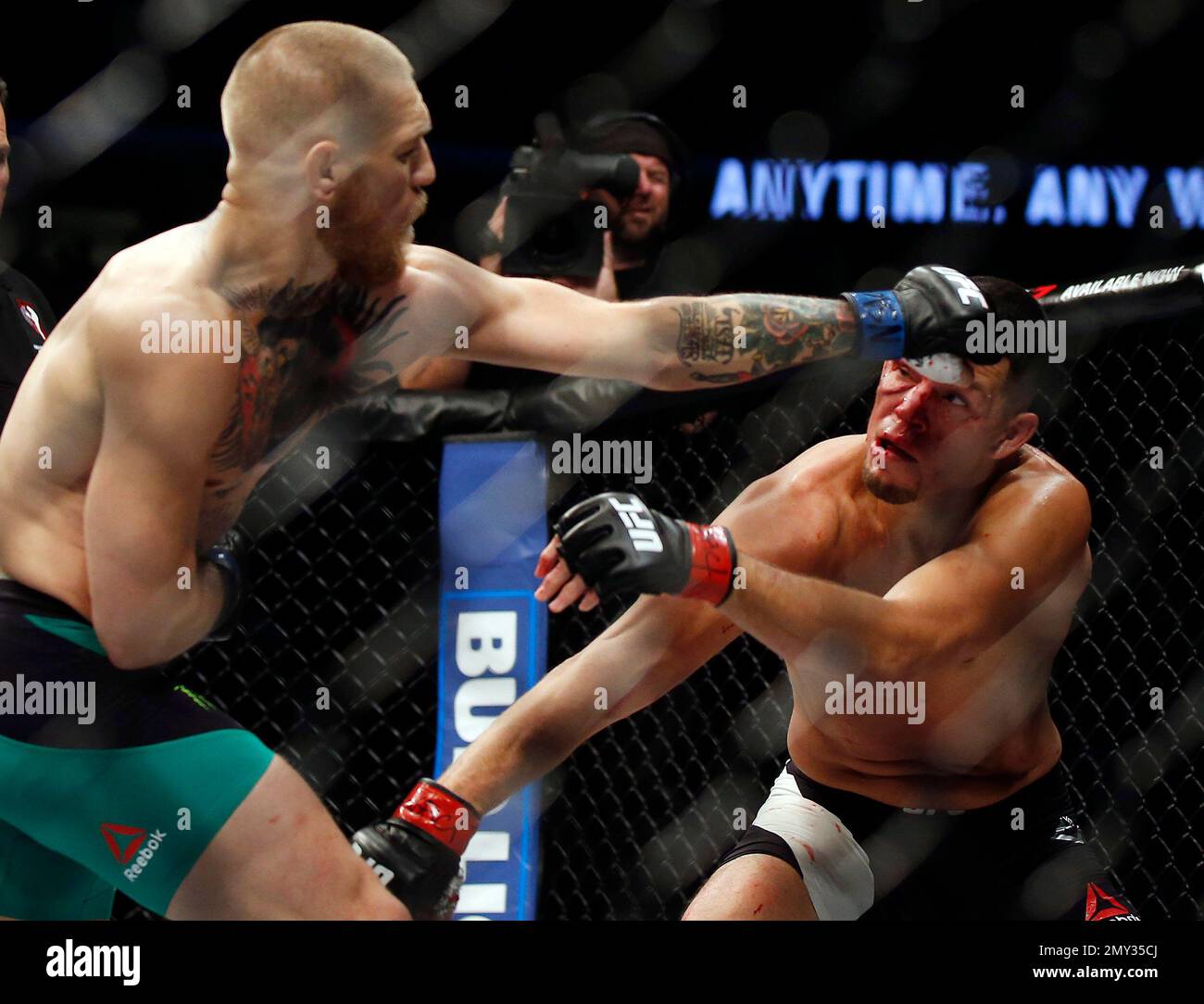 Conor McGregor, left, punches Nate Diaz during their welterweight mixed ...