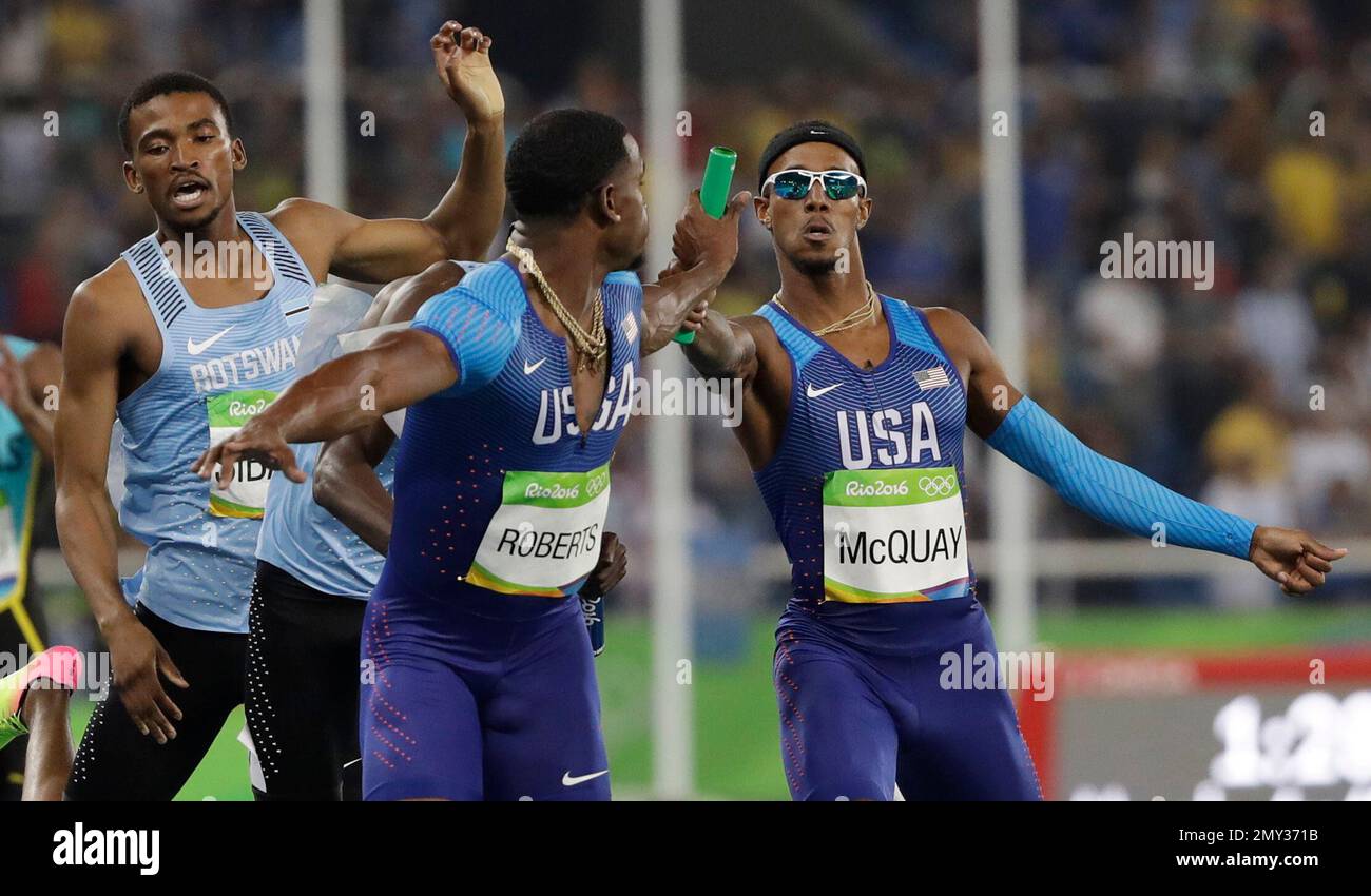 United States' Tony McQuay, right, passes the baton to Gil Roberts in ...