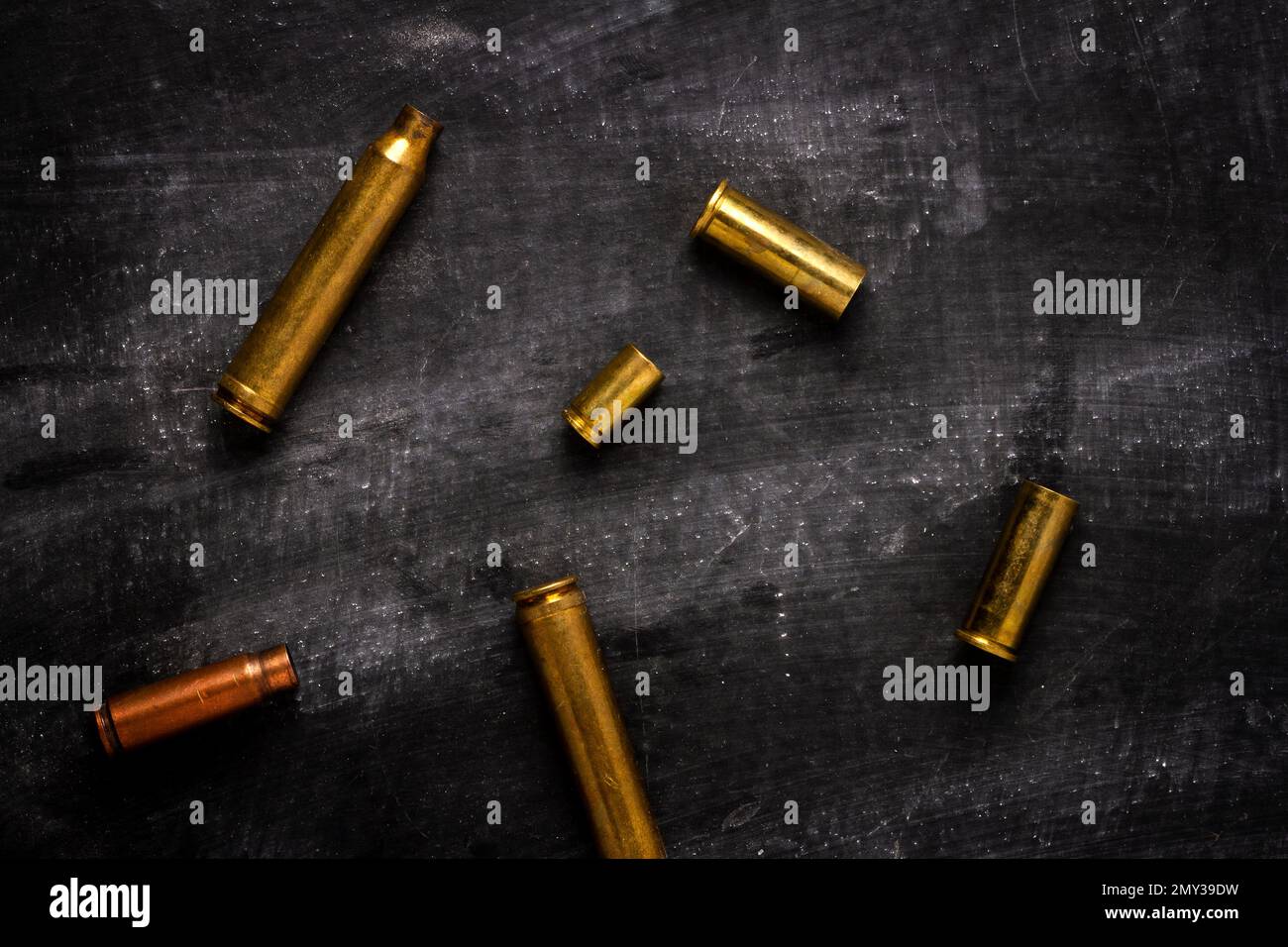 Empty bullet cartridges lying on the black background Stock Photo - Alamy