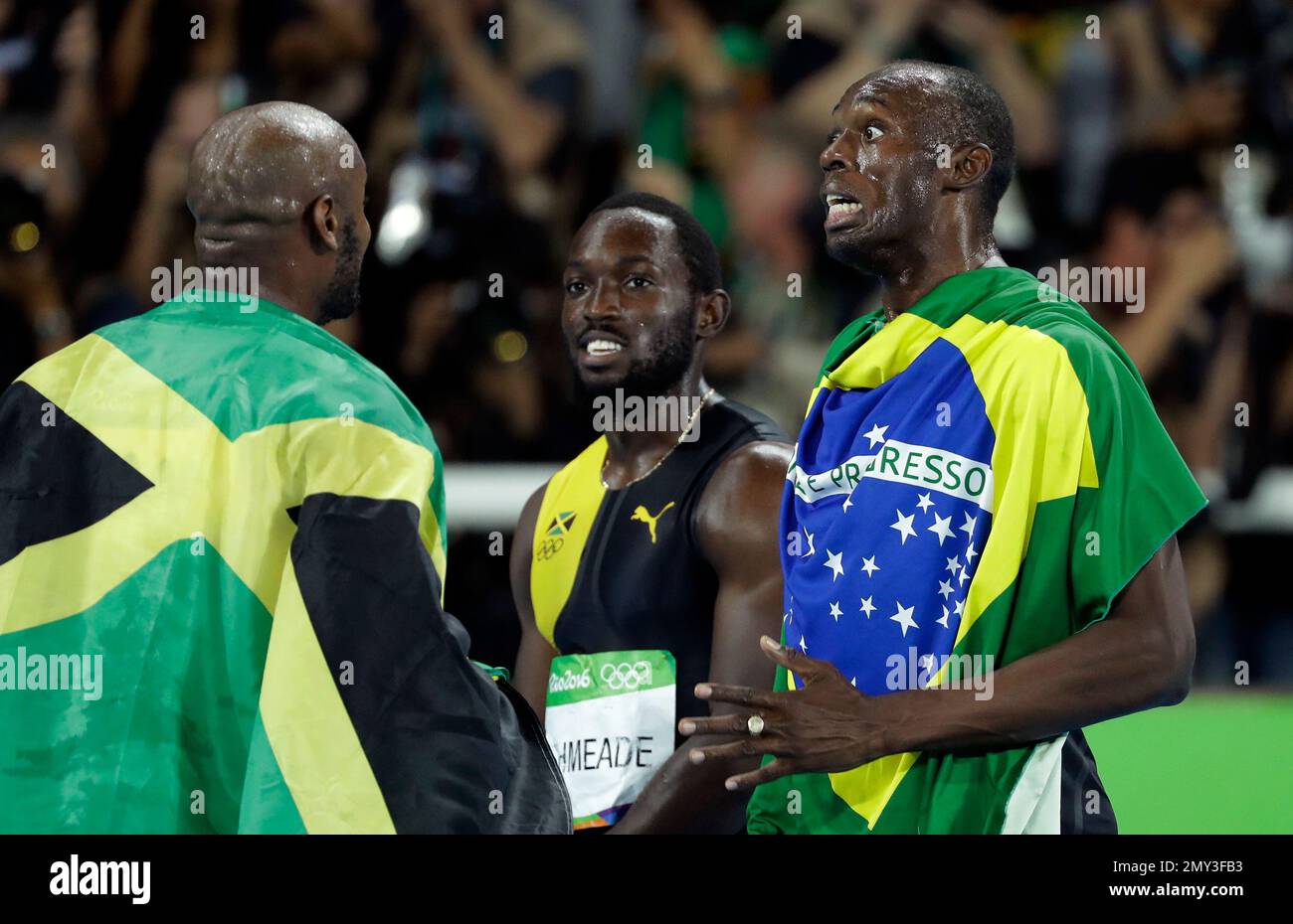 Jamaica's Asafa Powell, left, Nickel Ashmeade, center, and Usain Bolt celebrate winning the gold ...