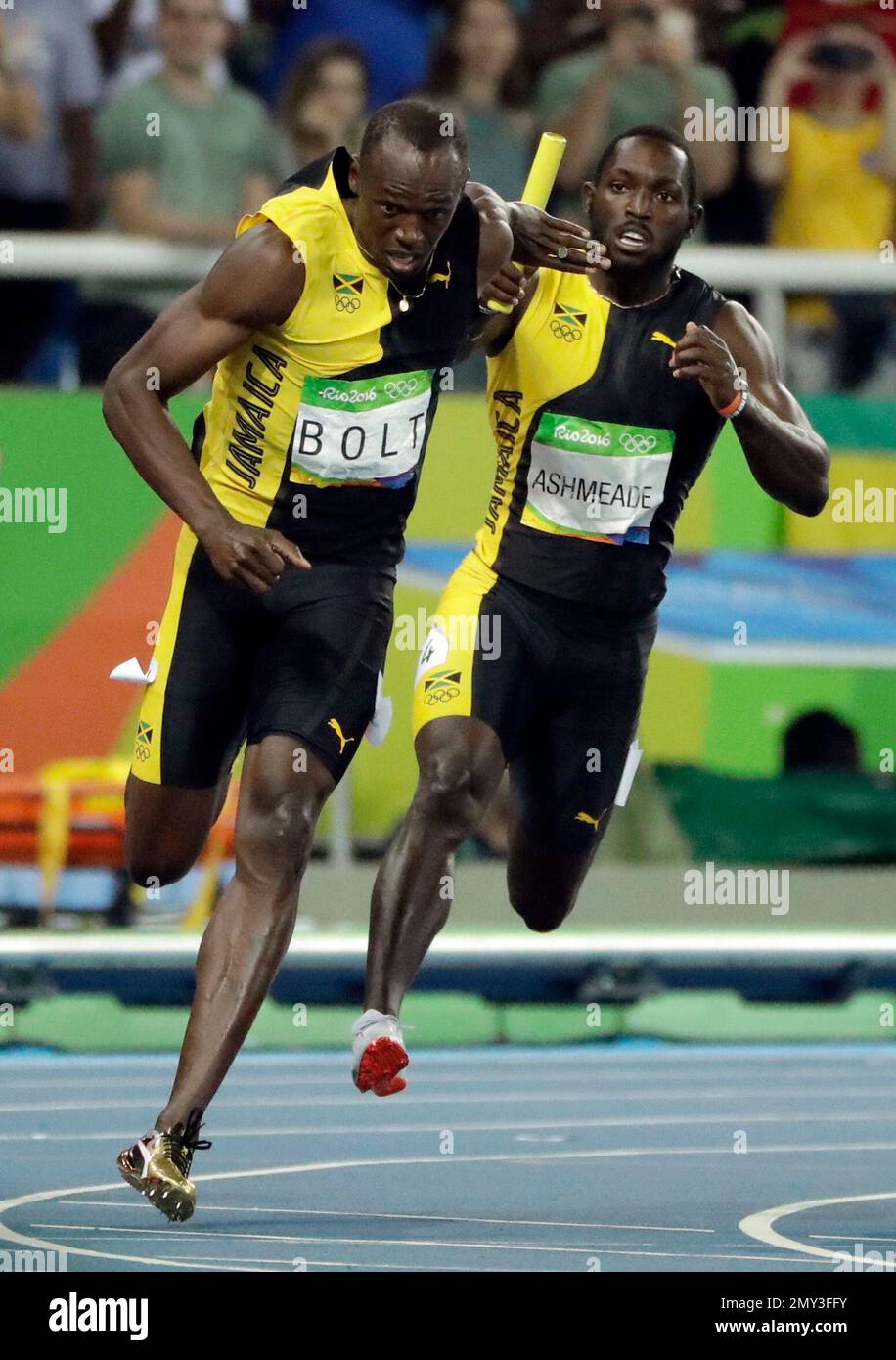 Jamaica's Nickel Ashmeade passes the baton to Usain Bolt in the men's ...