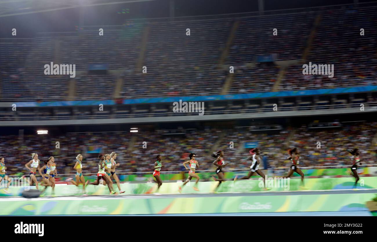 Athletes compete in the women's 5000-meter final during the athletics ...