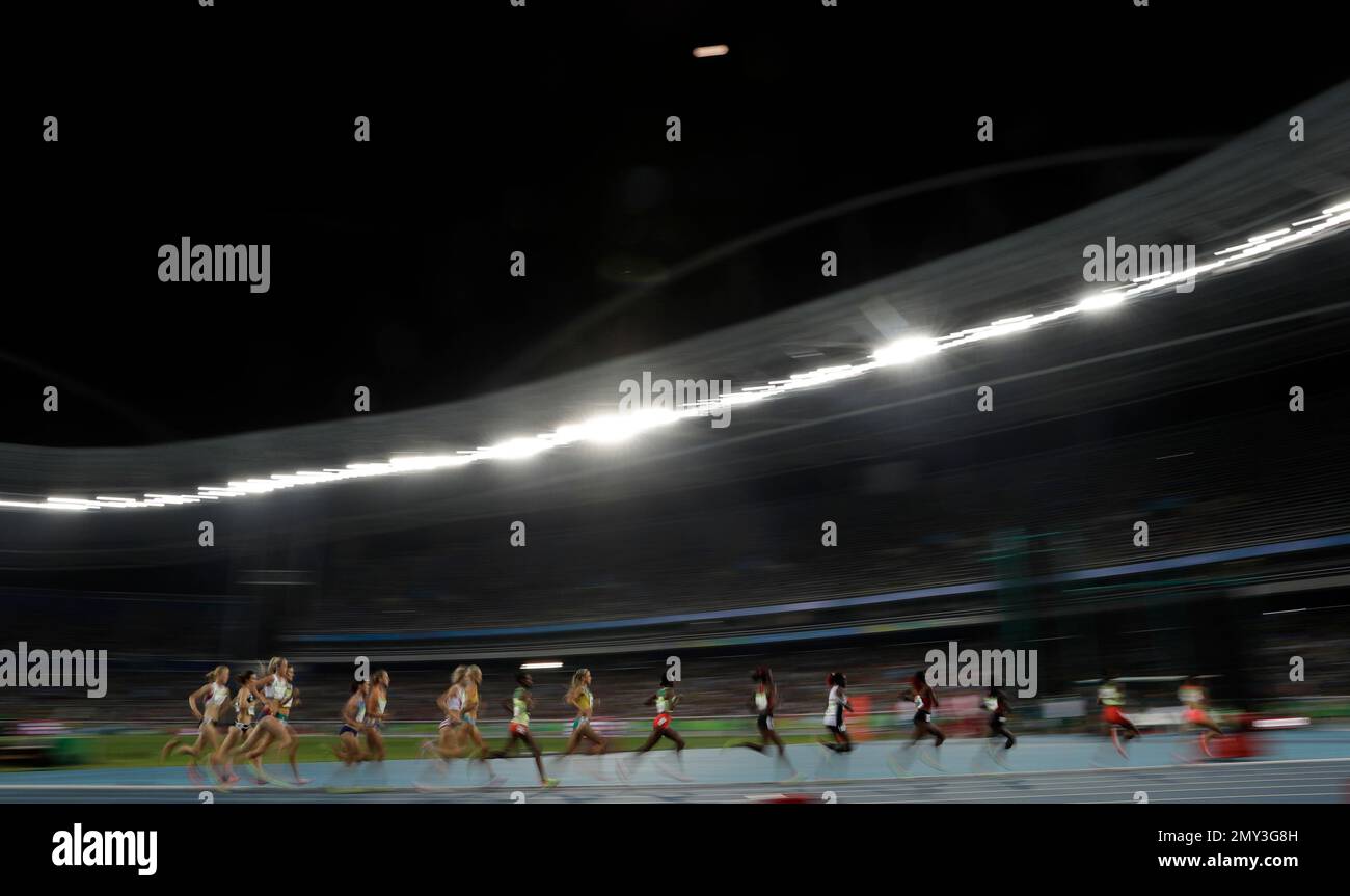 Athletes compete in the women's 5000-meter final during the athletics ...