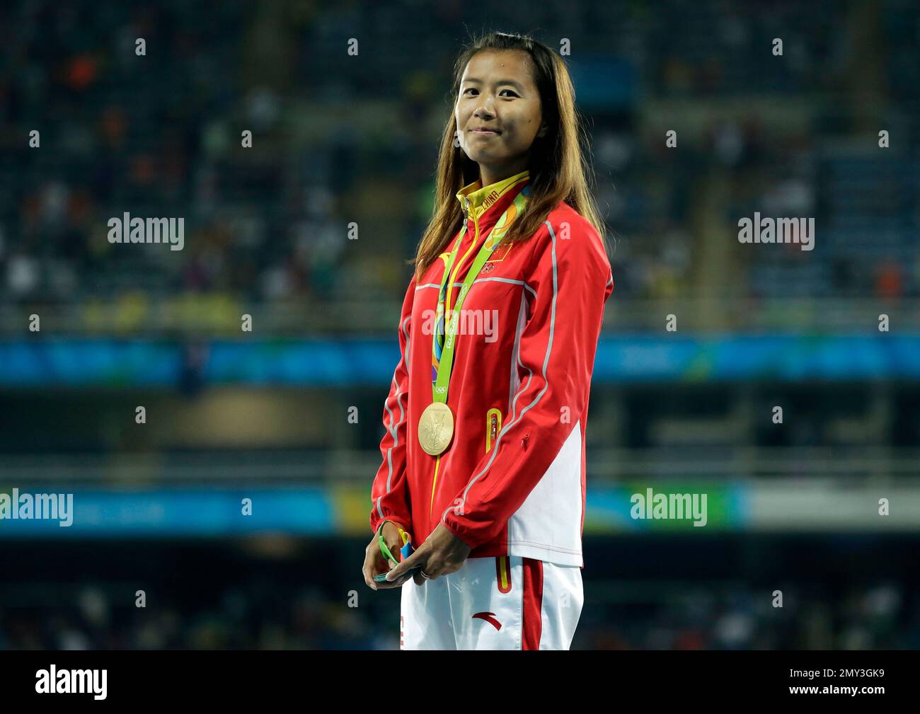 Gold medal winner China's Hong Liu smiles during the award ceremony for ...