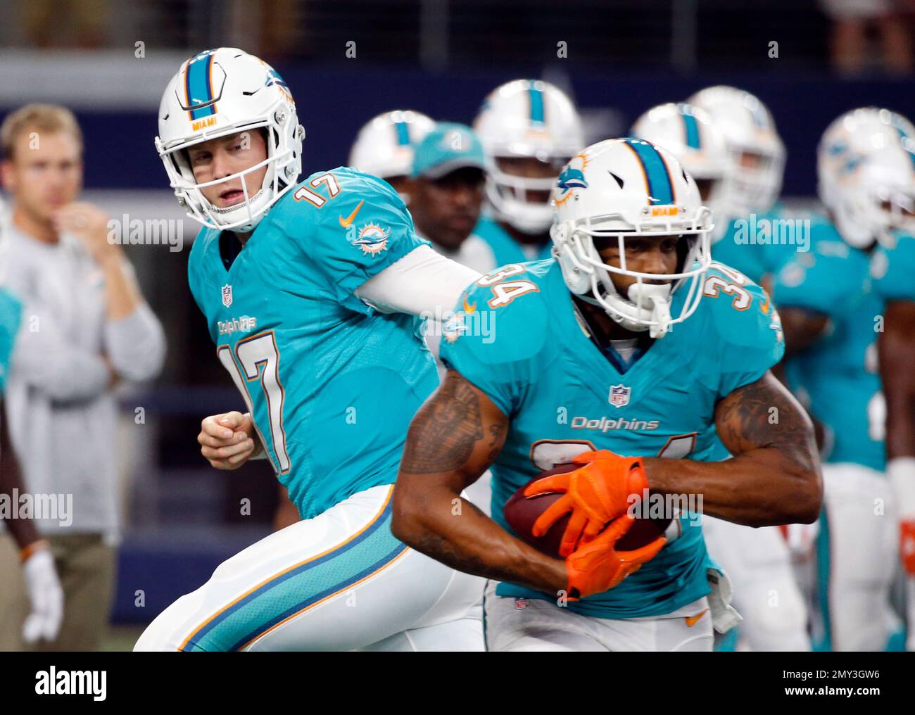 Miami Dolphins quarterback Ryan Tannehill (17) hands the ball off to ...