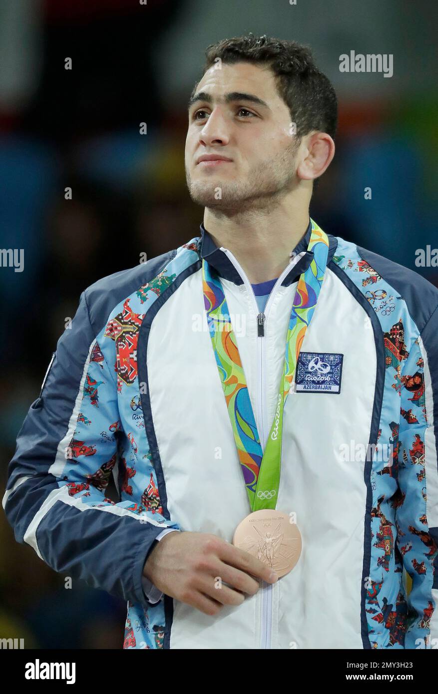 Azerbaijan's Haji Aliyev stands on the podium after winning the bronze ...