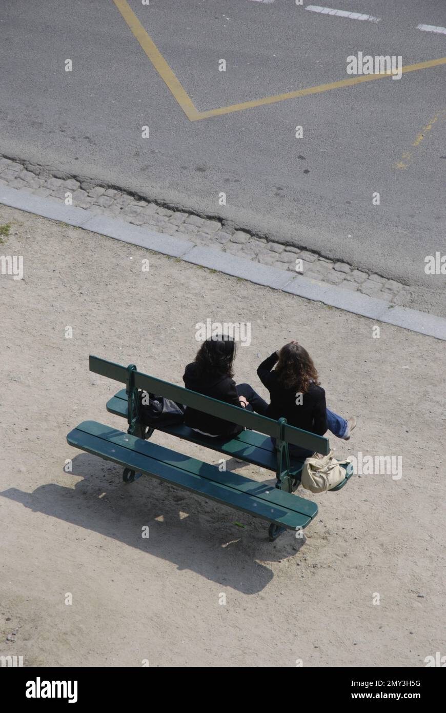 Two women are talking on a park bench Stock Photo - Alamy