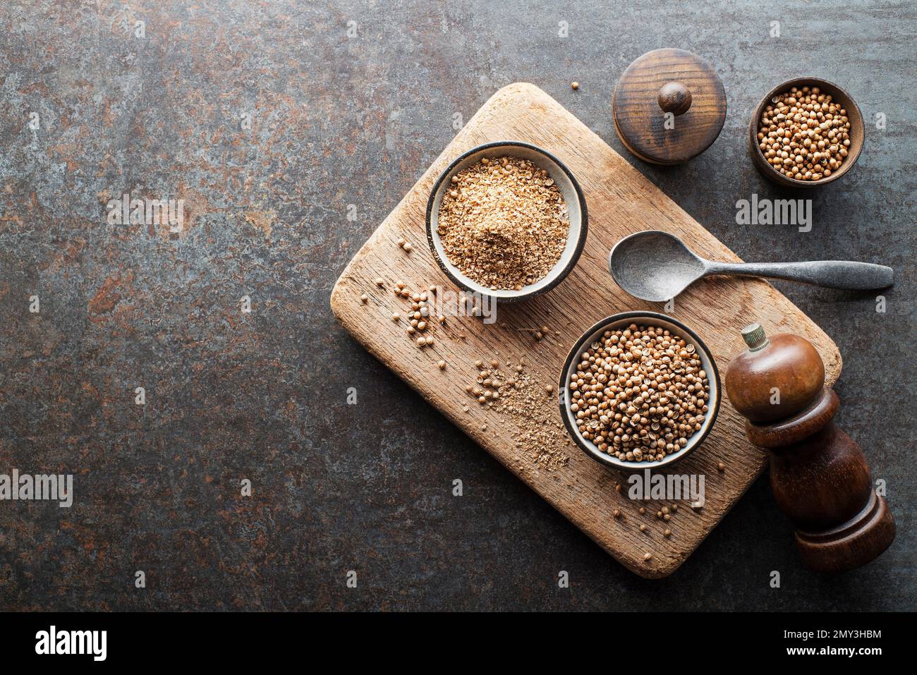 Organic Dried coriander seeds (Coriandrum sativum) and powder on rustic ...
