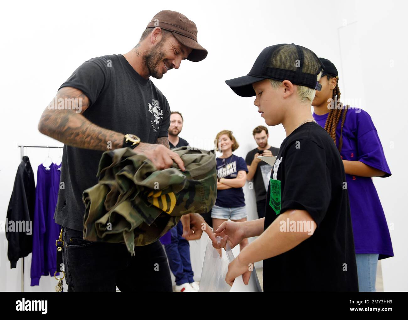 David Beckham, left, and his son Cruz pick out clothes at Kanye West's ...