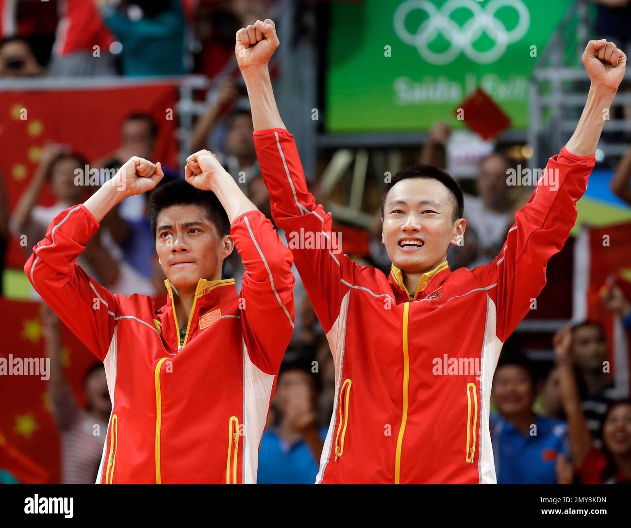China's Fu Haifeng, left, and Zhang Nan celebrate on the winners' stand ...
