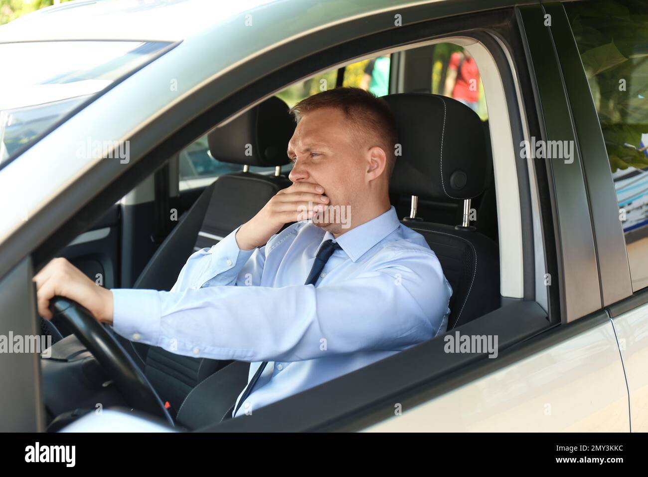 Exhausted young businessman yawning hi-res stock photography and images ...