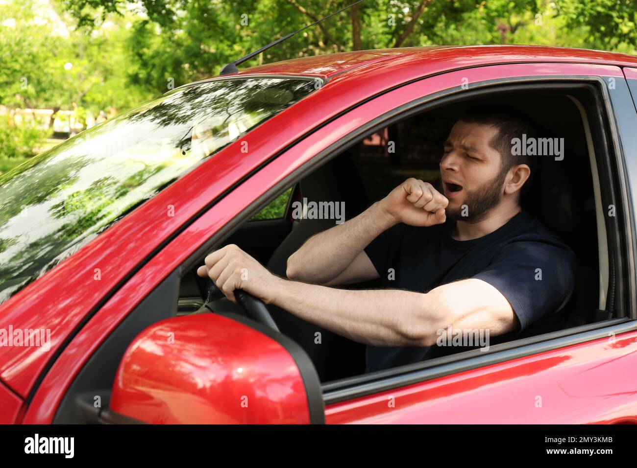 Tired man yawning while driving his modern car Stock Photo - Alamy