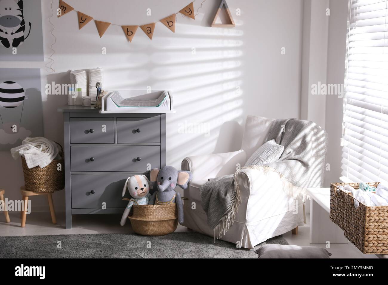 Chest of drawers with changing tray and pad in baby room. Interior ...