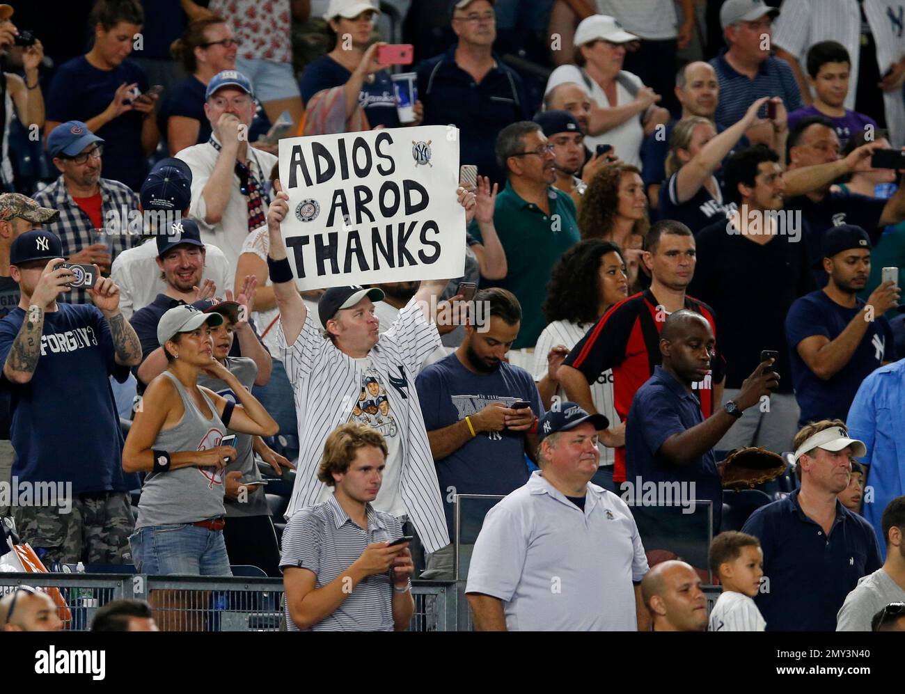 A fan holds up a farewell sign for New York Yankees designated hitter ...