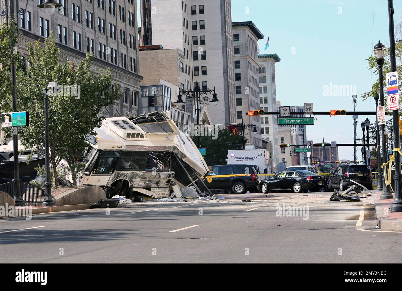 A bus is tipped on its side after two commuter buses collided in Newark ...