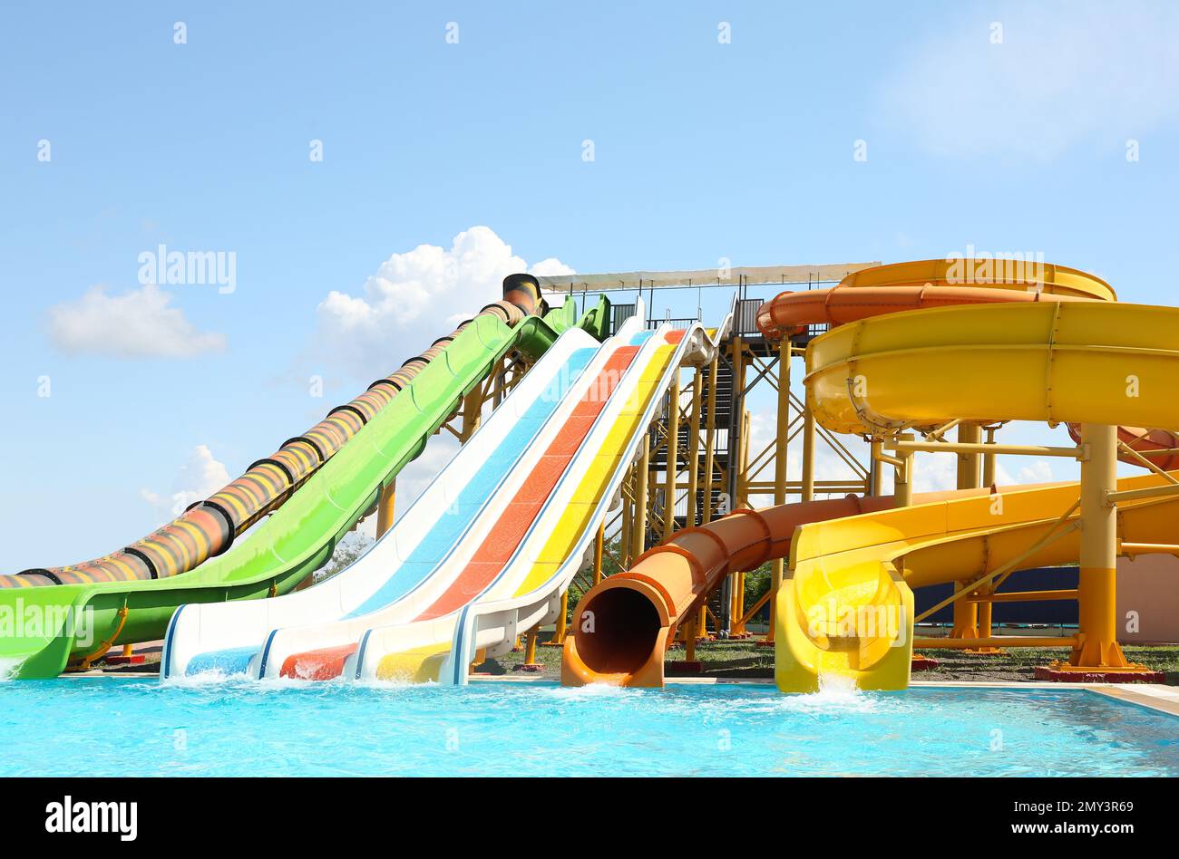 Different colorful slides in water park on sunny day Stock Photo - Alamy