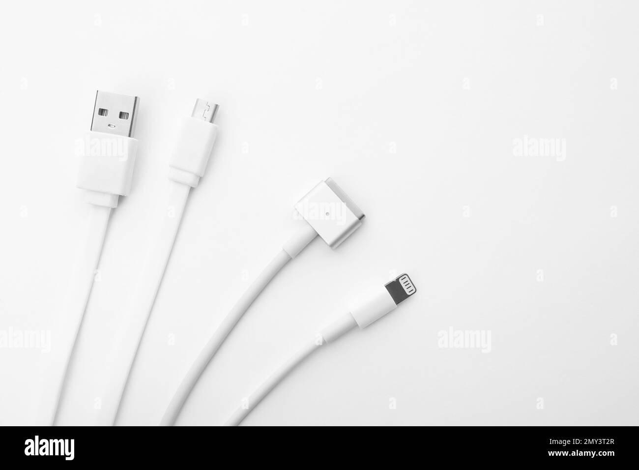 Charge cables on white background, top view. Modern technology Stock ...