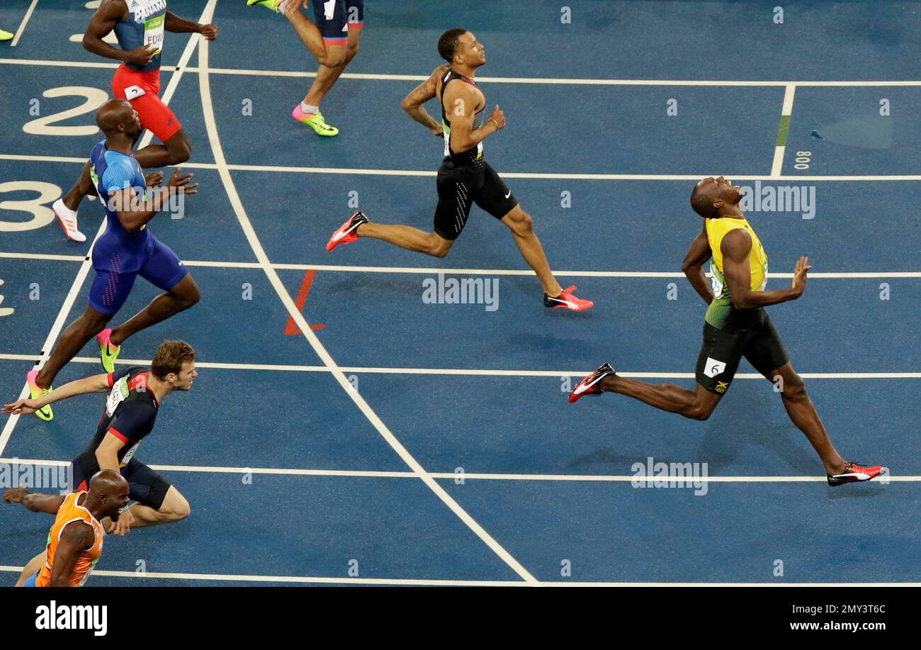 Usain Bolt from Jamaica celebrates after crossing the line to win the ...
