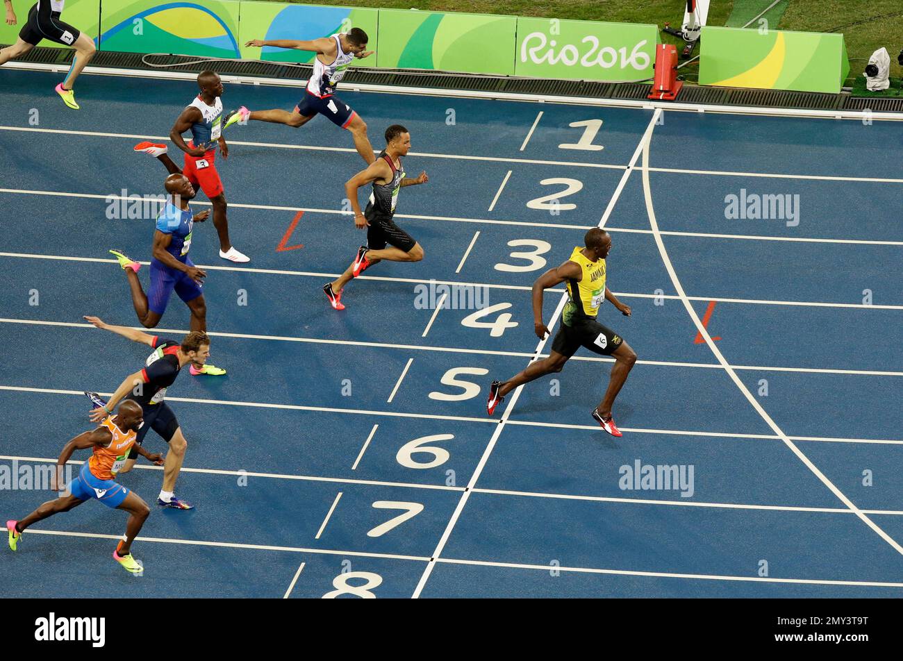 Usain Bolt from Jamaica celebrates after crossing the line to win the ...