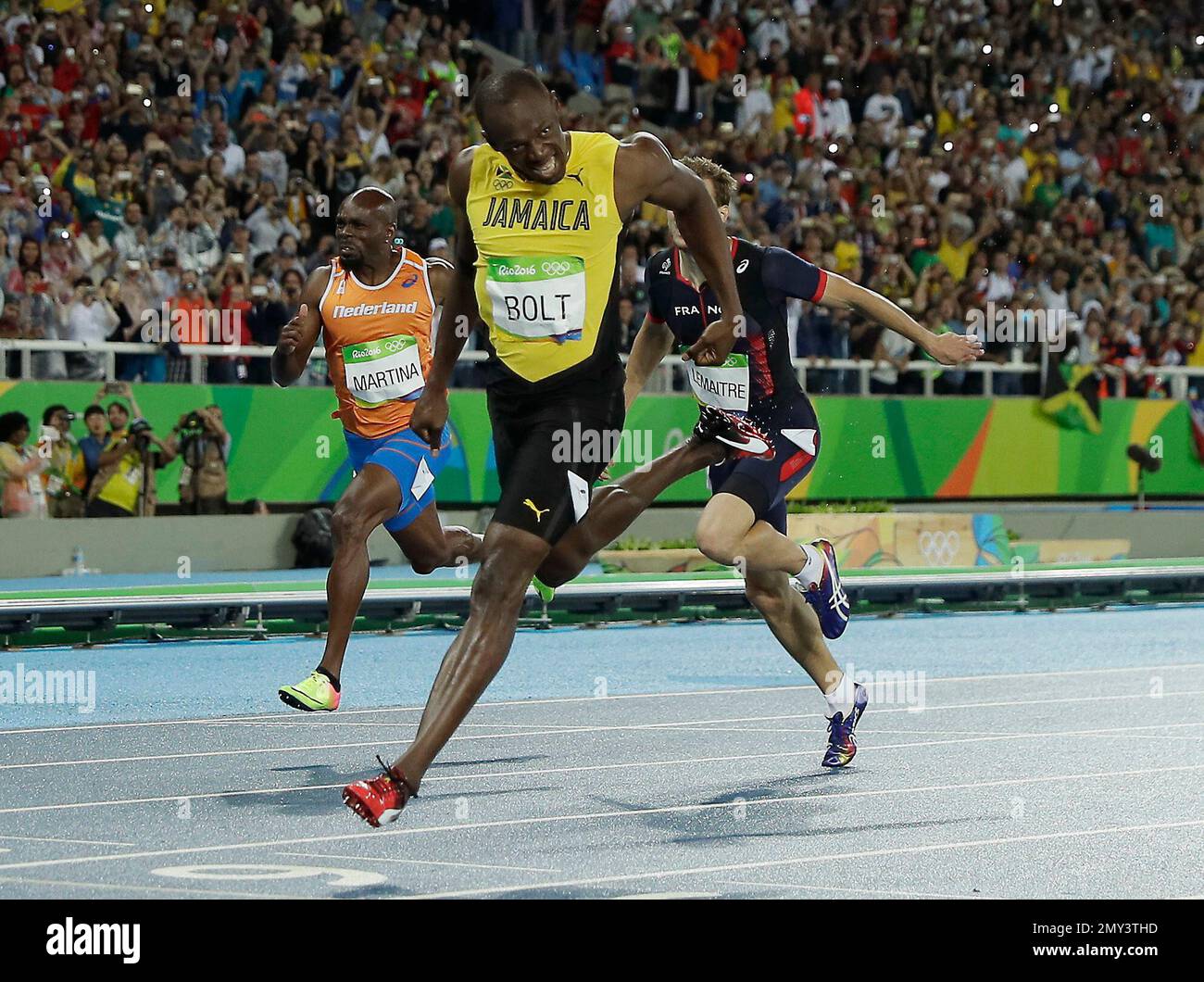 Usain Bolt from Jamaica crosses the line to win the gold medal in the ...