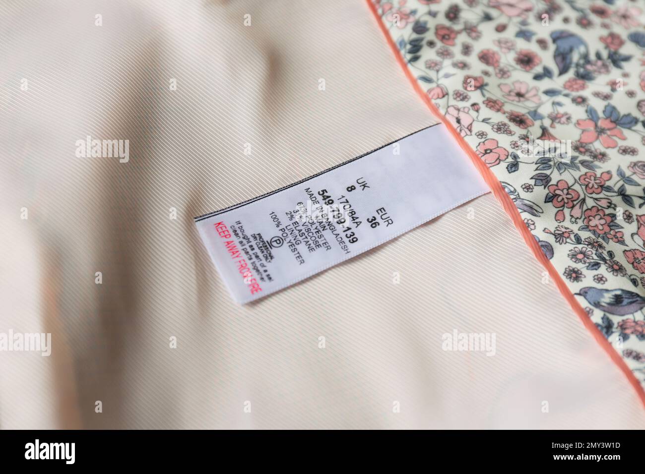 Clothing label with size and content information on light garment ...