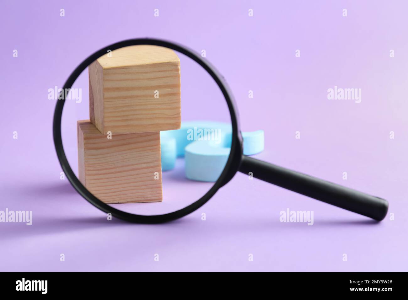 Magnifier glass, wooden cubes and letter A on violet background ...