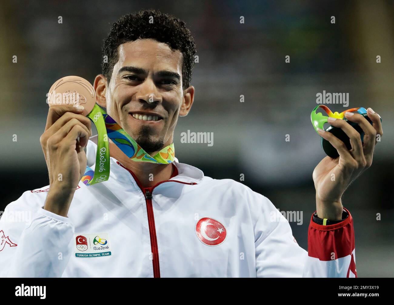 Turkey's Yasmani Copello displays his bronze medal for the men's 400 ...