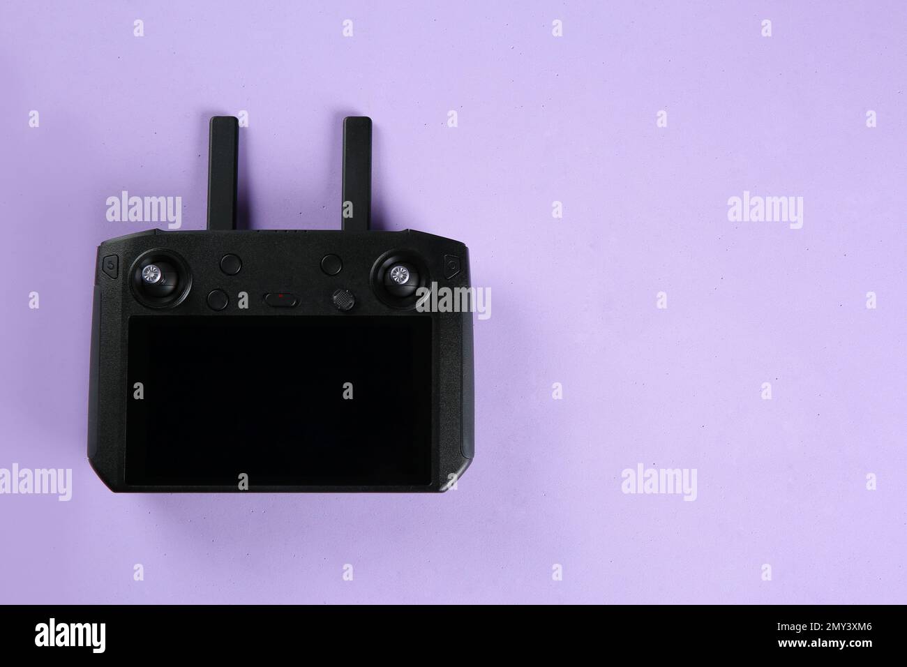 New modern drone controller on lilac background, top view. Space for ...