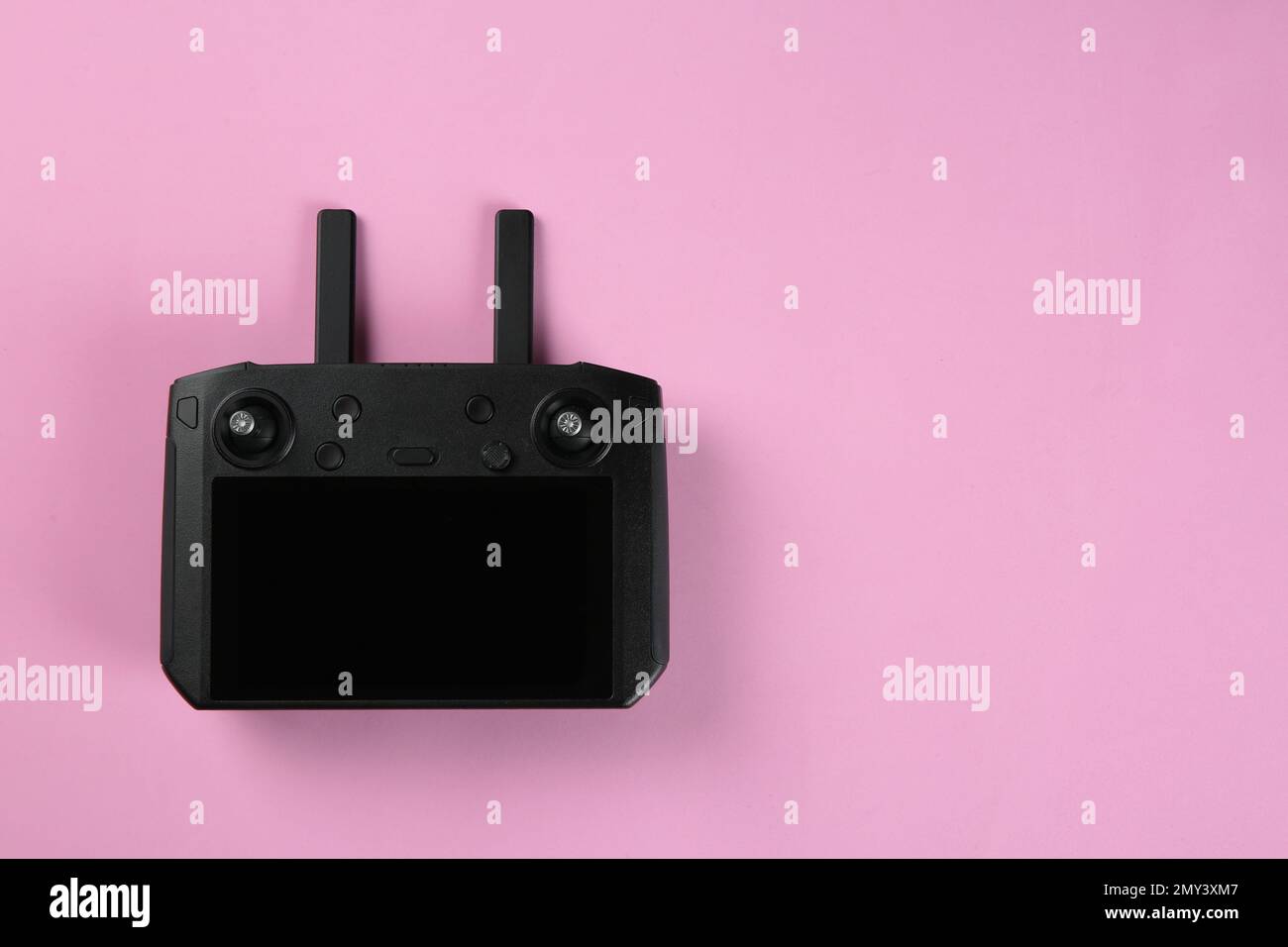 New modern drone controller on pink background, top view. Space for ...