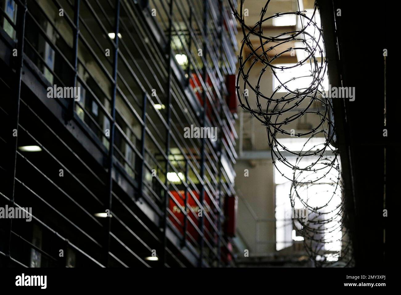 Barbed wire is seen inside the east block of death row at San Quentin ...