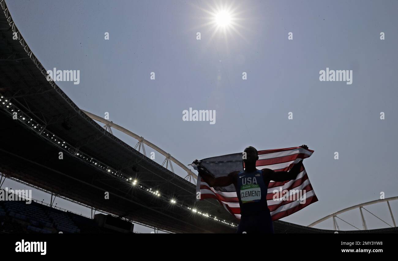 United States' Kerron Clement poses with the U.S. flag after winning ...