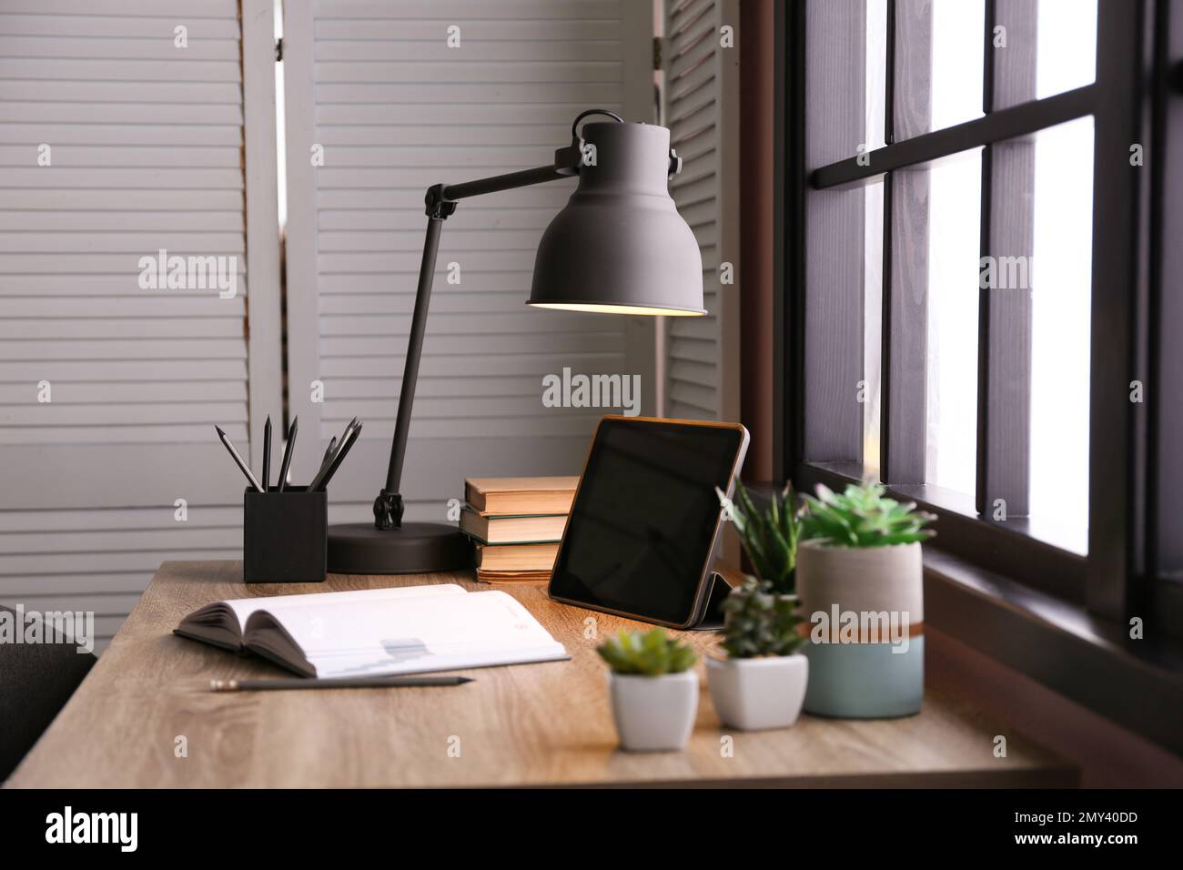 Stylish room interior with comfortable workplace near window Stock ...