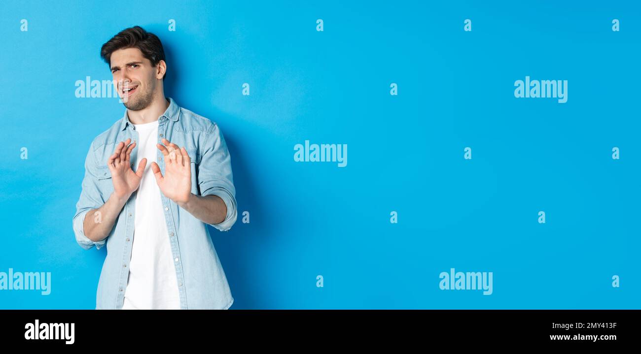 Displeased man refusing, saying no and cringe from something disgusting ...