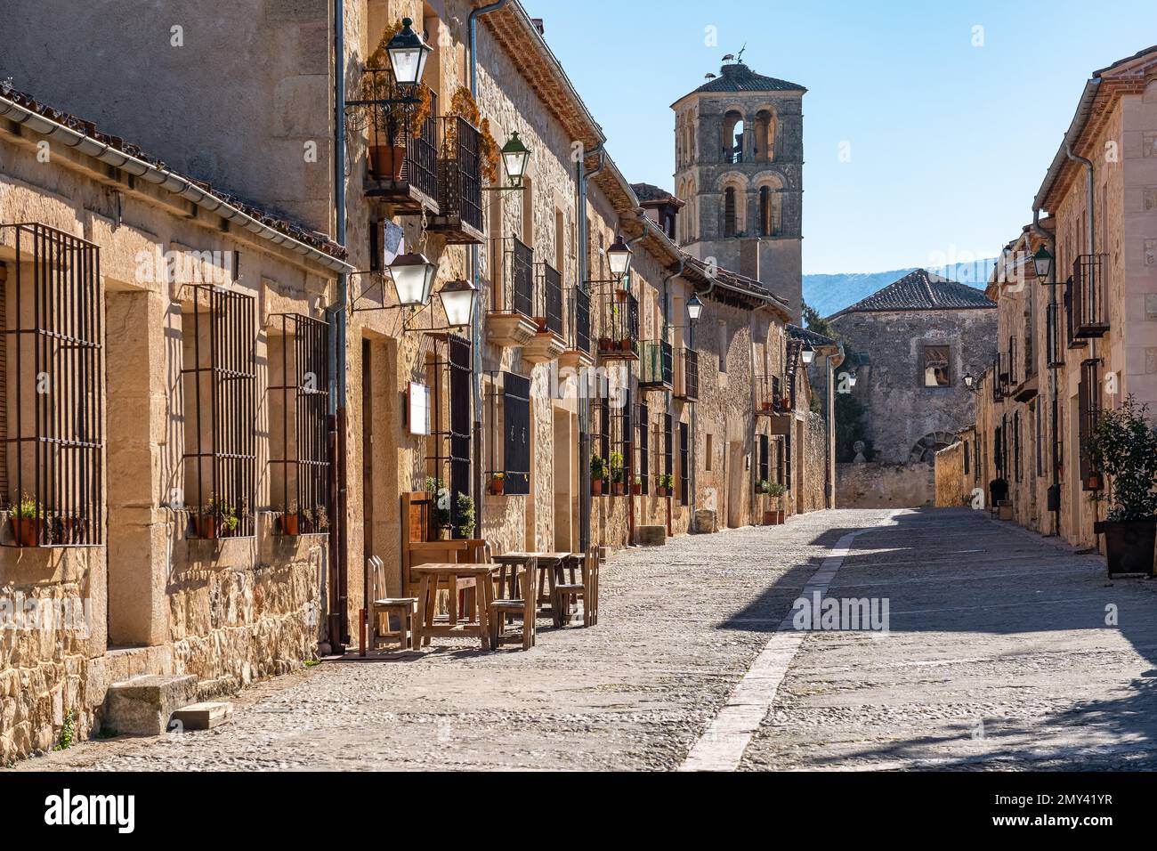 Street of beautiful medieval buildings with church tower in the ...
