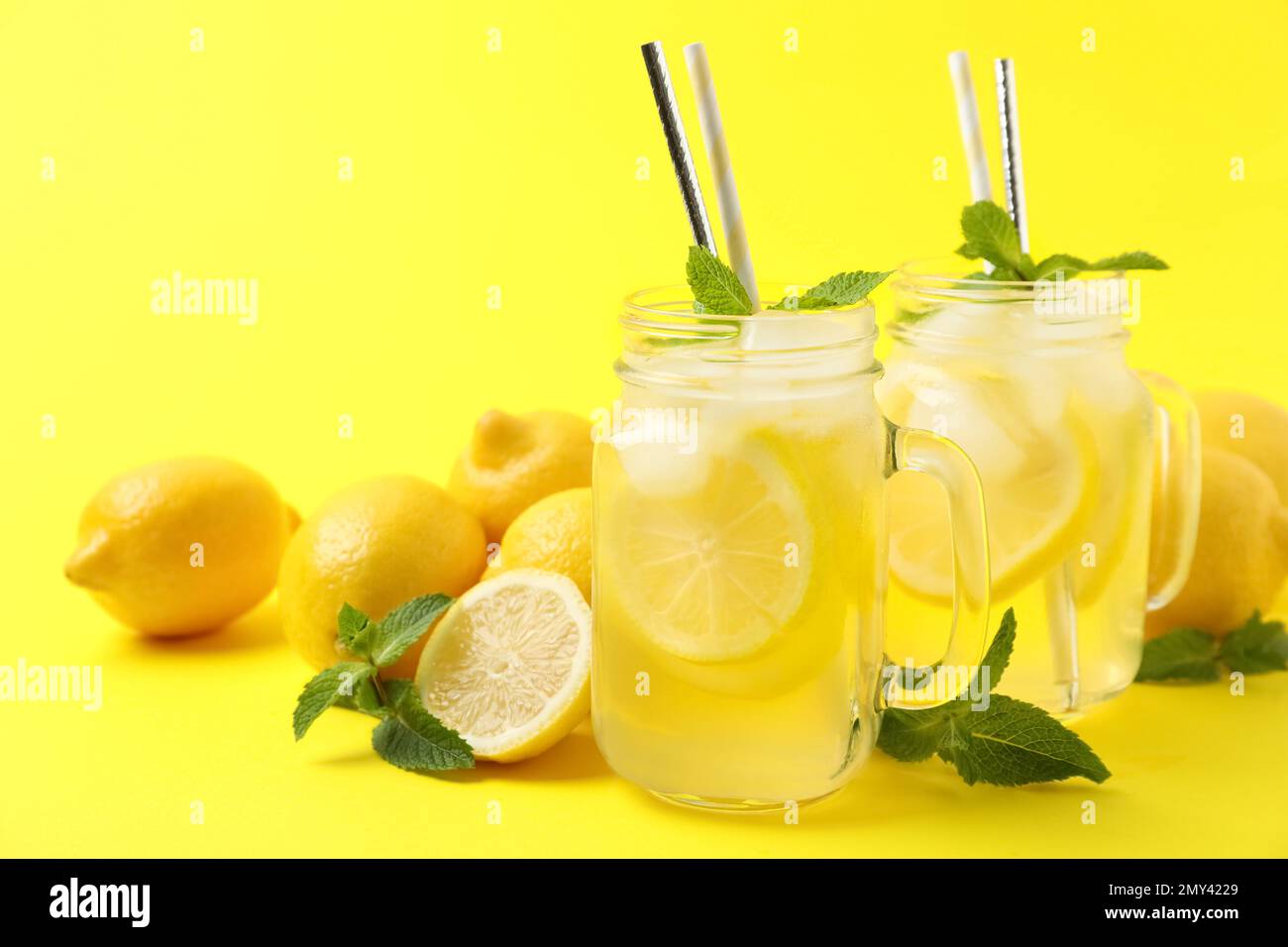 Freshly made natural lemonade on yellow background. Summer refreshing ...